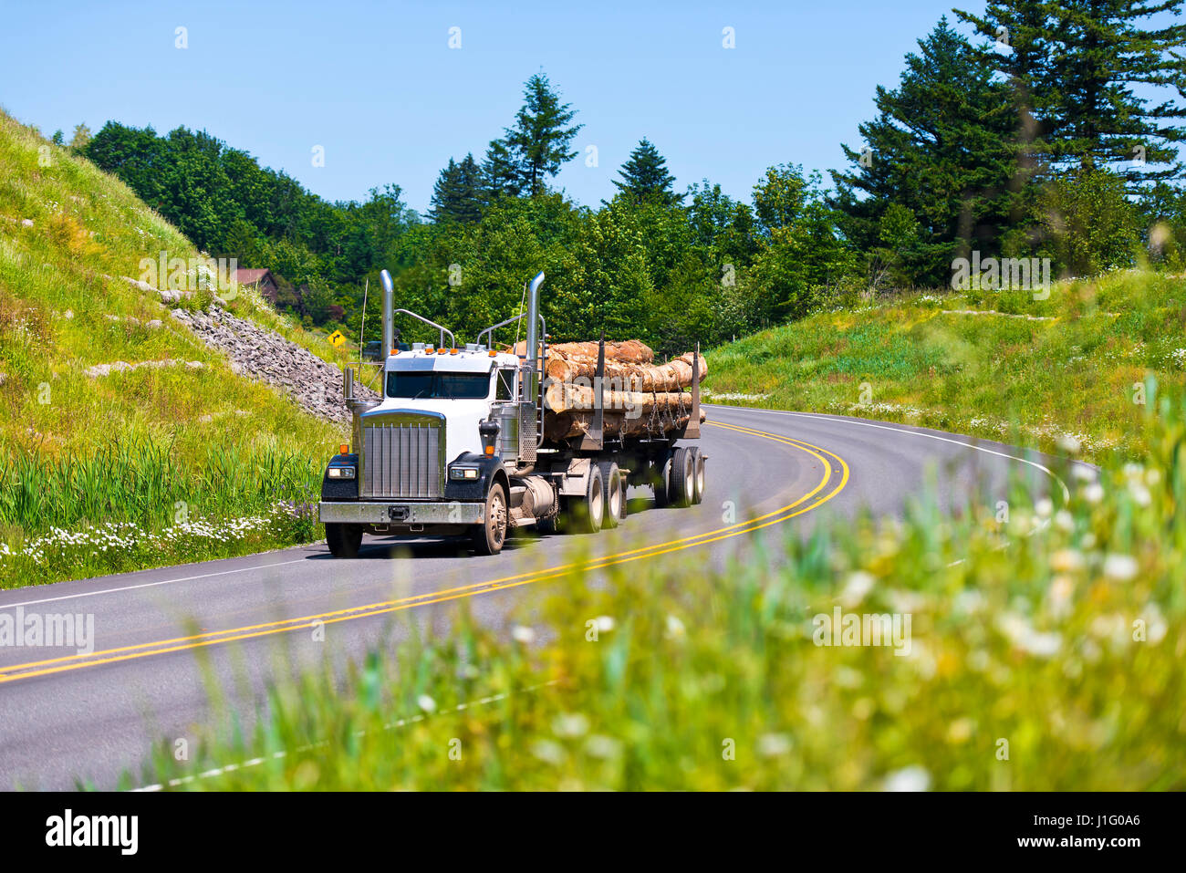 Large classic style truck with two chrome tailpipes on the bend in the ...