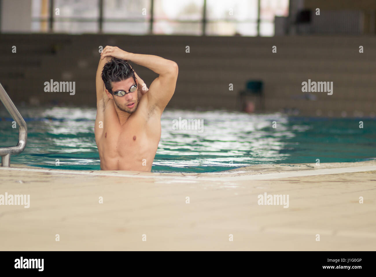 swimmer in pool water, stretching arms, indoors Stock Photo - Alamy