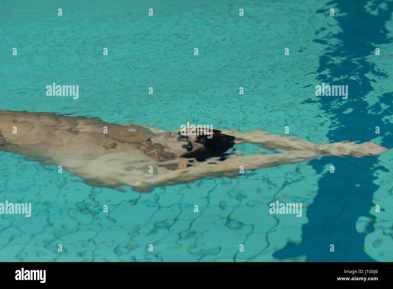 swimmer swimming back underwater, swimming pool Stock Photo - Alamy
