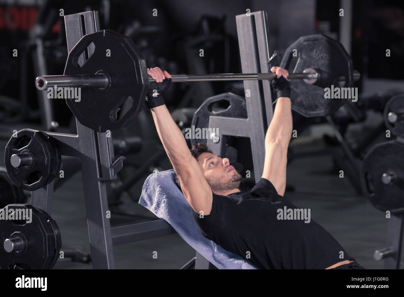 young man lying laying, utility bench weights bar exercise fitness ...