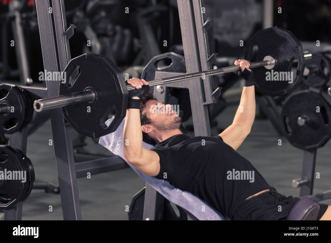 young man lying laying, utility bench weights bar exercise fitness ...