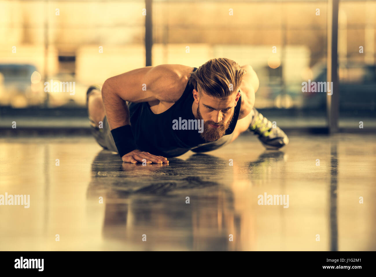 Young handsome bearded man doing push ups exercise in gym Stock Photo ...