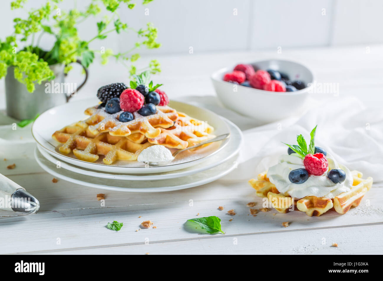 Delicious and sweet waffles with berry fruits and whipped cream Stock ...