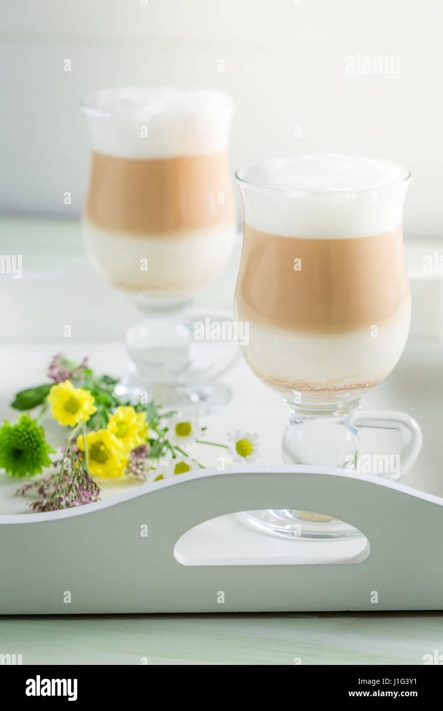 Two latte coffee with spring flowers on white table Stock Photo - Alamy