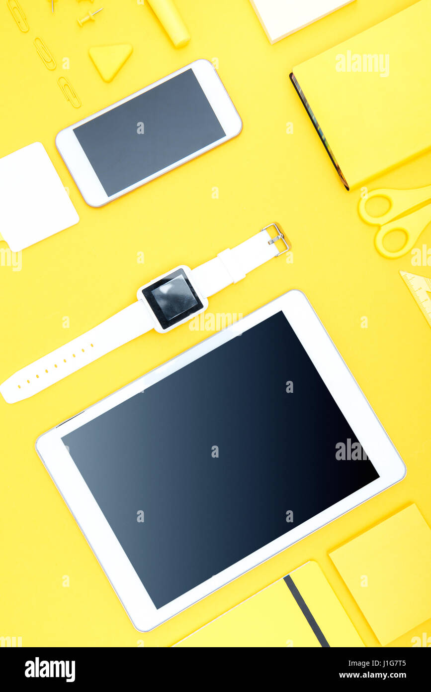 Top view of digital tablet, smartphone, smartwatch and office supplies ...