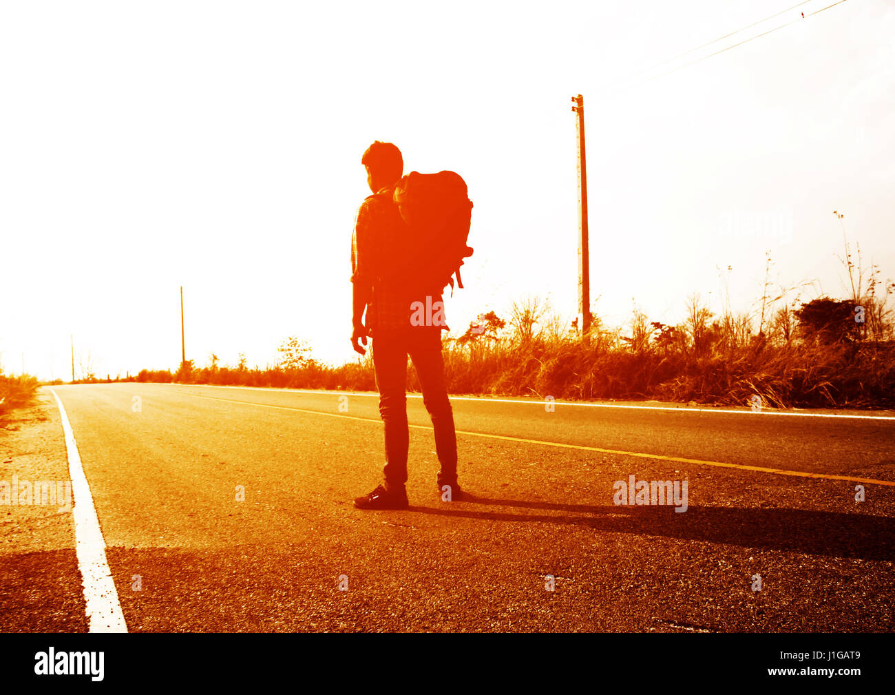 Traveler with backpack on the road Stock Photo - Alamy