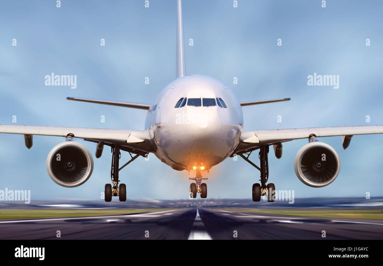 Airplane taking off from airport runway Stock Photo - Alamy