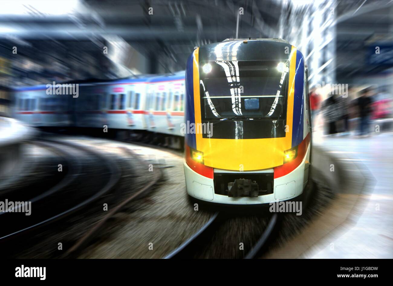 Fast moving train leaving station platform with motion blur Stock Photo ...