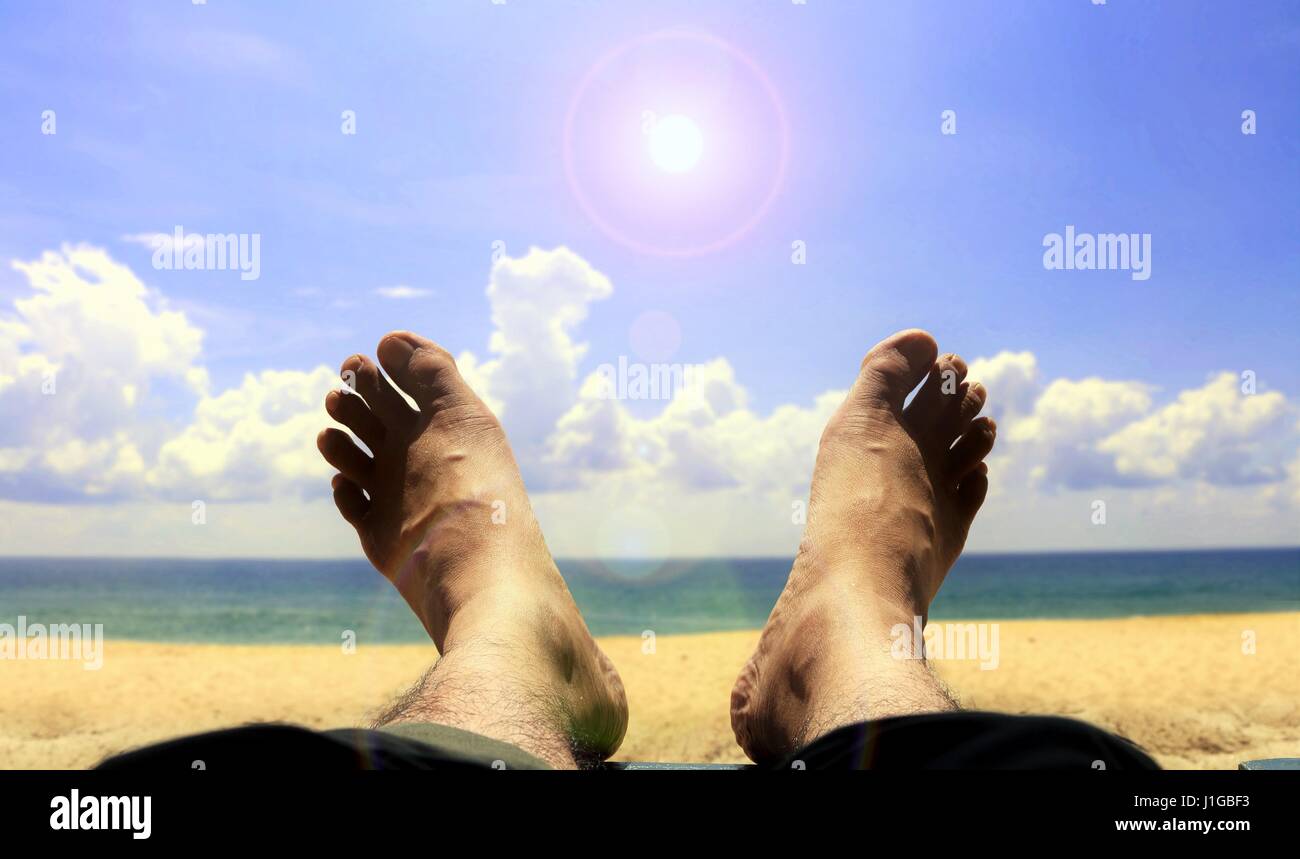 Foot on the beach with bright sunlight Stock Photo - Alamy