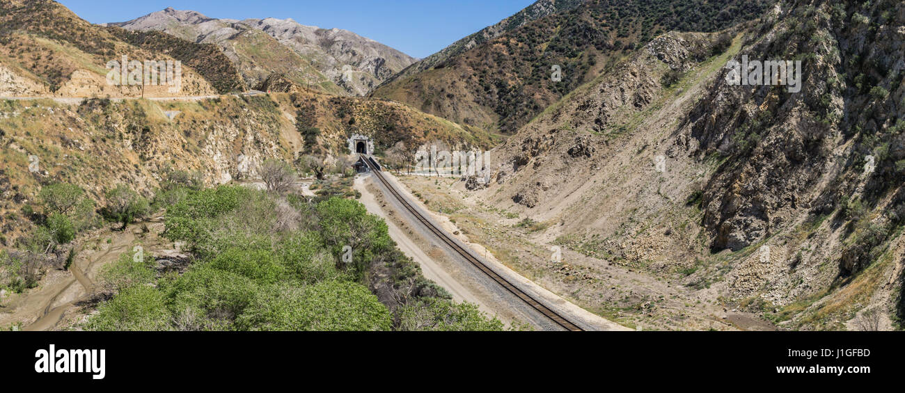 Desert railroad track in southern California leads into a tunnel in the ...