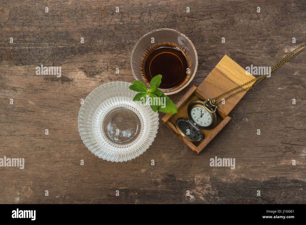 Clock and alcohol on brown wood table concept creative new project ...