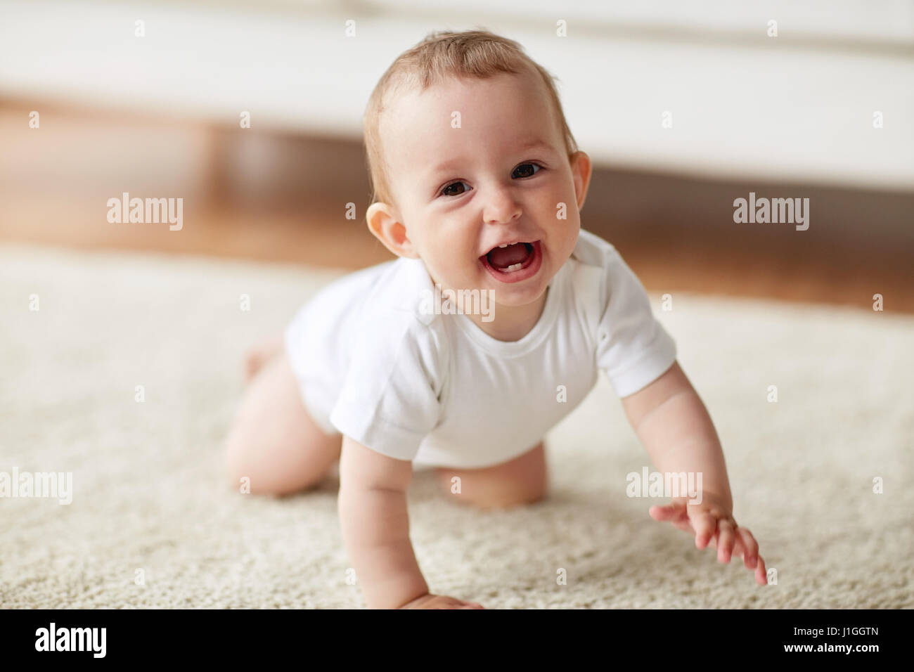 little baby in diaper crawling on floor at home Stock Photo - Alamy