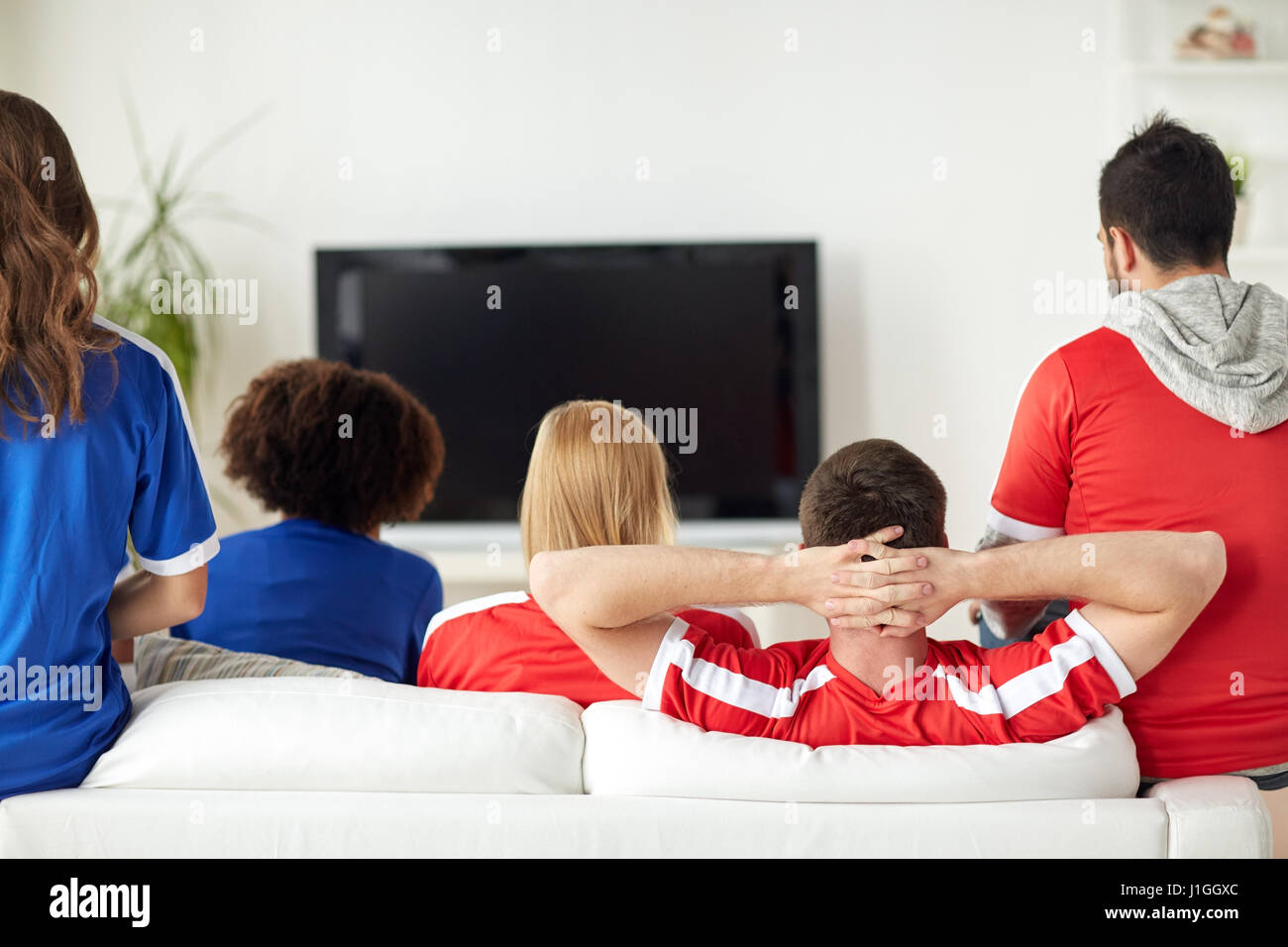friends or football fans watching tv at home Stock Photo - Alamy