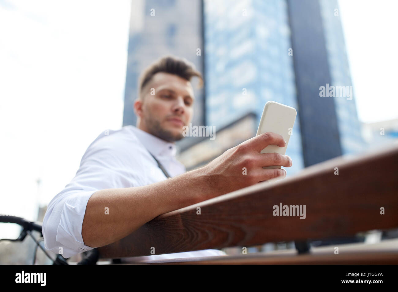 Businessman texting on smartphone sitting hi-res stock photography and ...