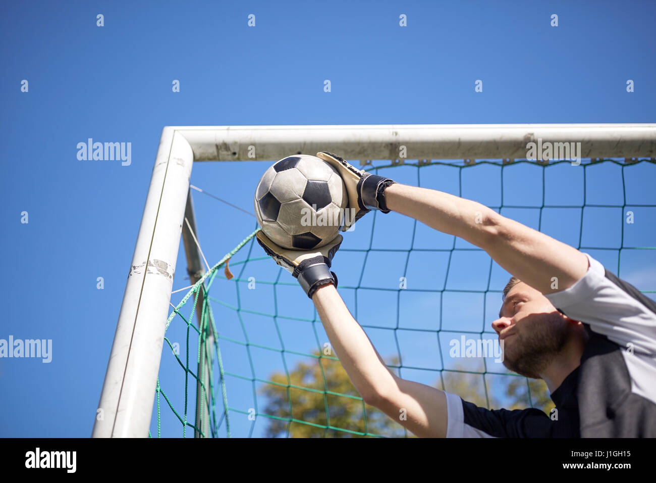 goalkeeper with ball at football goal on field Stock Photo - Alamy