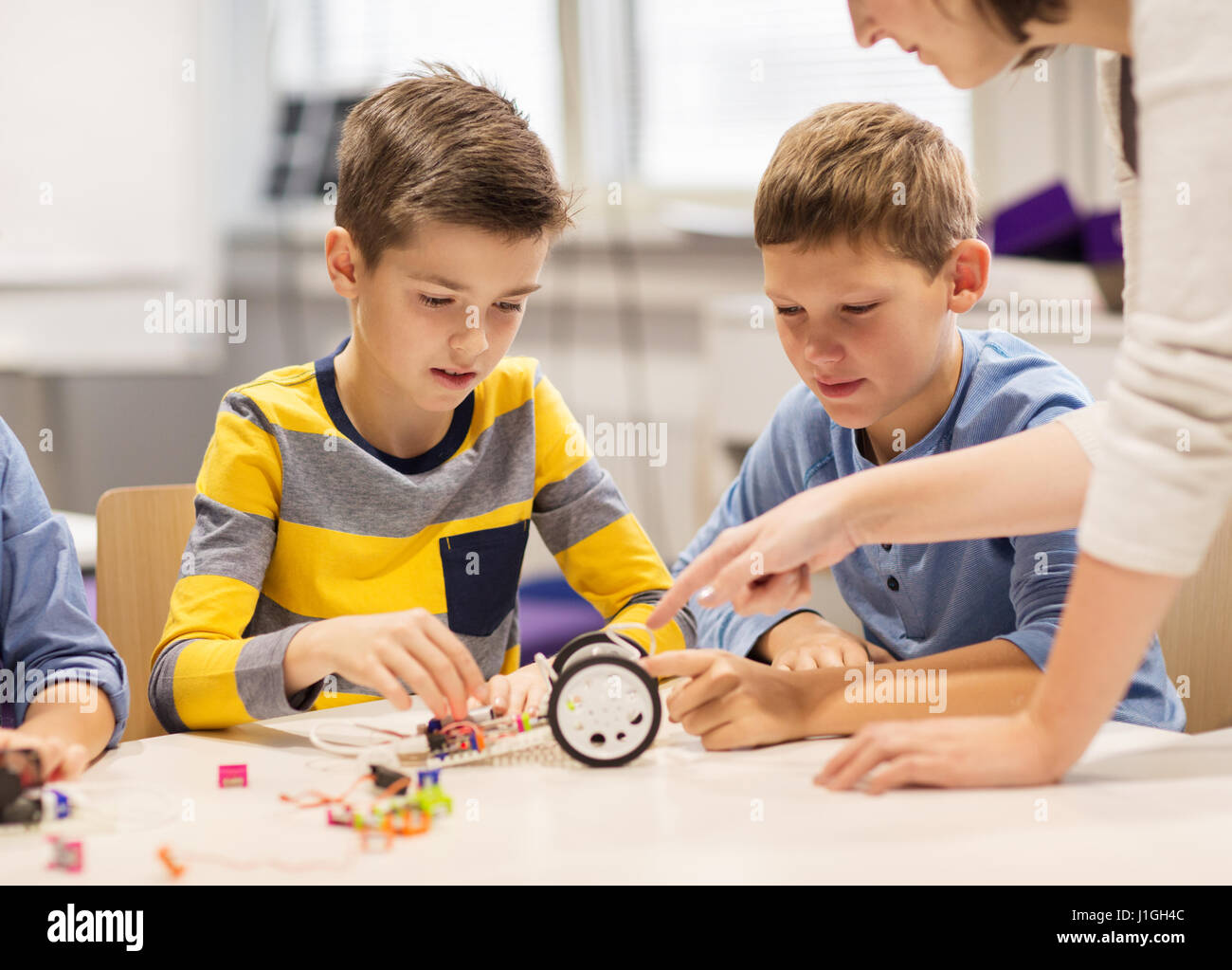 happy children building robot at robotics school Stock Photo - Alamy
