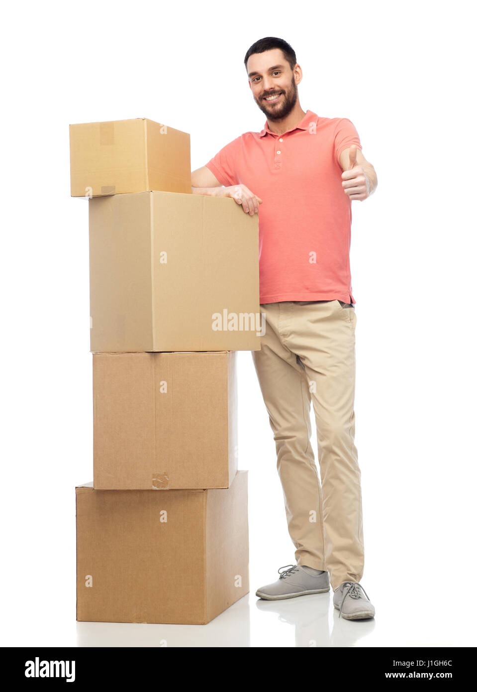 happy man with cardboard boxes showing thumbs up Stock Photo - Alamy