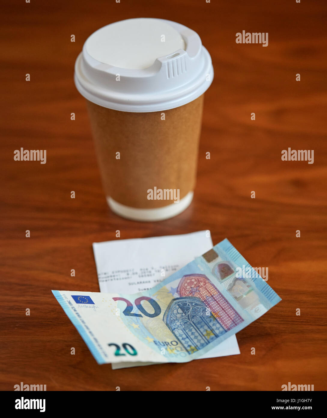 coffee in paper cup, bill and money on table Stock Photo - Alamy