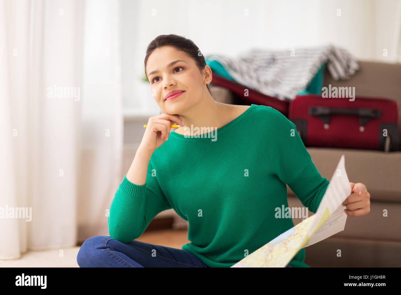 happy young woman with travel map at home Stock Photo - Alamy