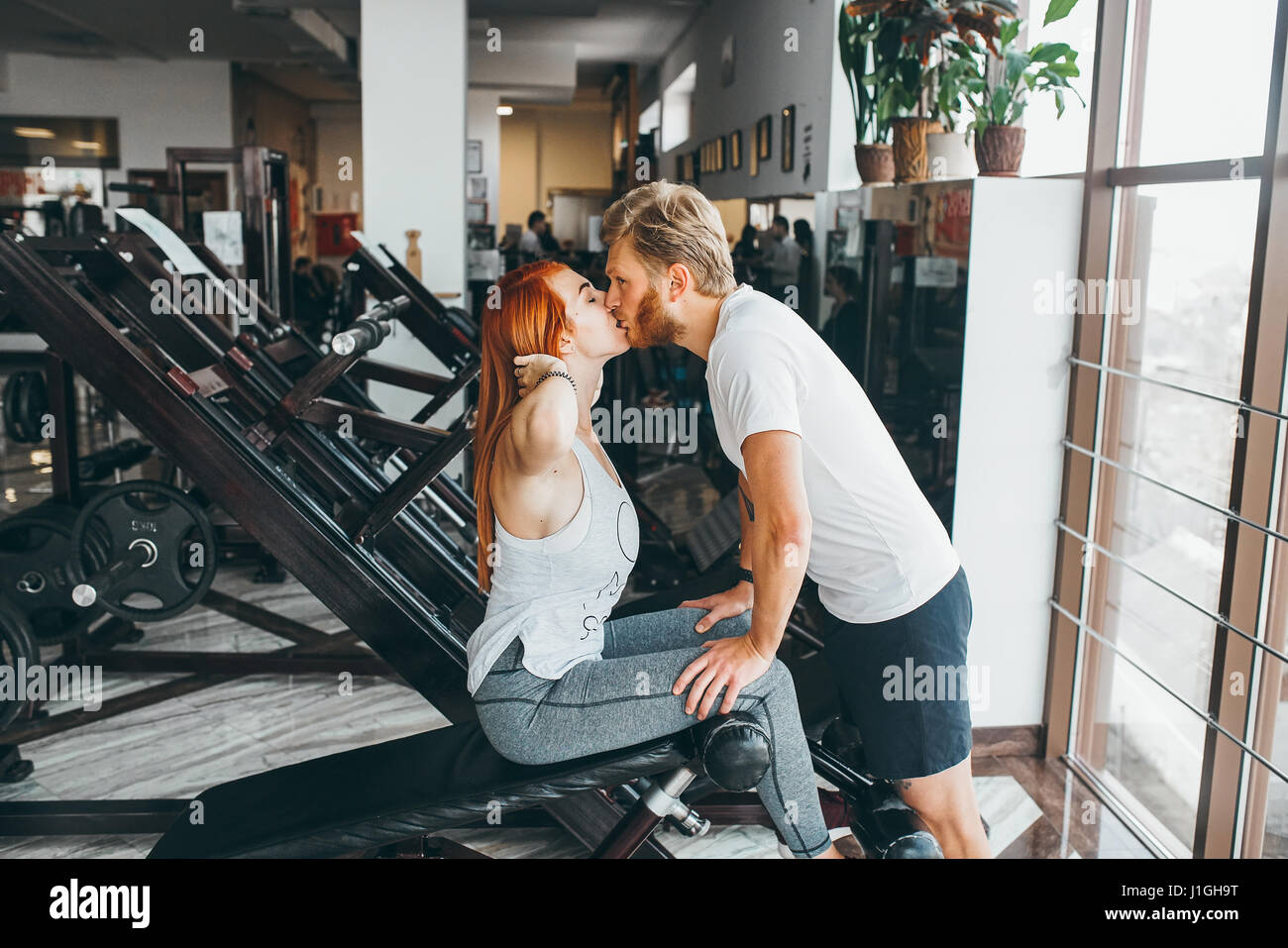 guy kiss girlfriend on training in gym Stock Photo - Alamy