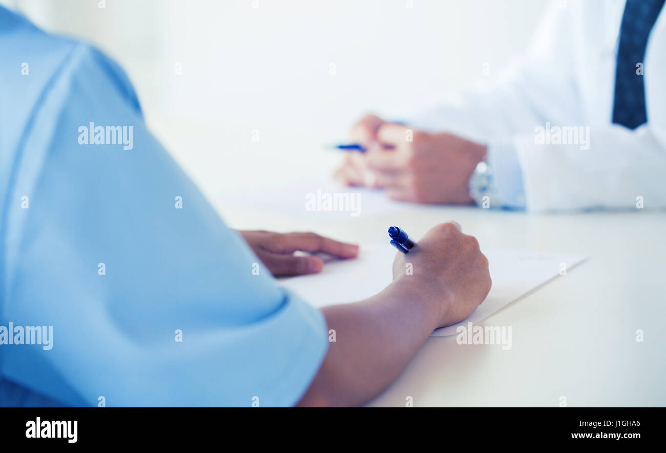 close up of doctor taking notes at hospital Stock Photo - Alamy
