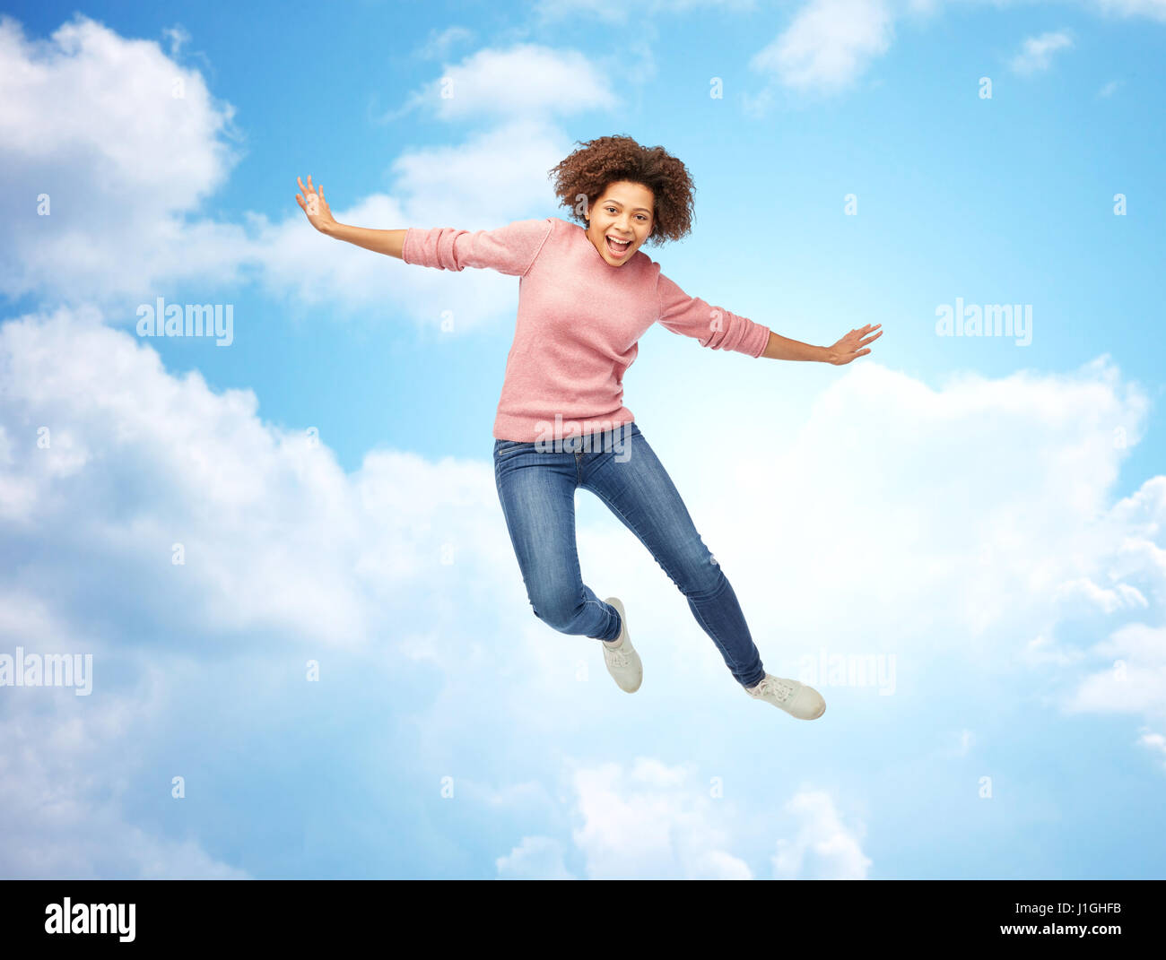 happy african american woman jumping over white Stock Photo - Alamy