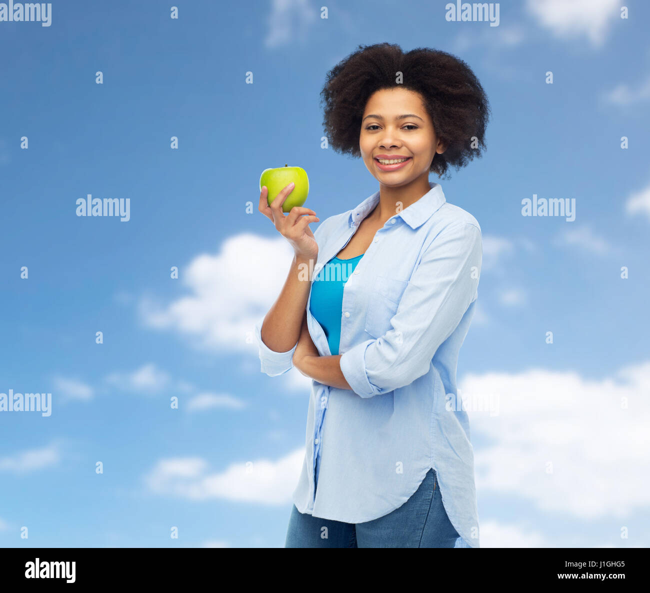 happy african american woman with green apple Stock Photo - Alamy