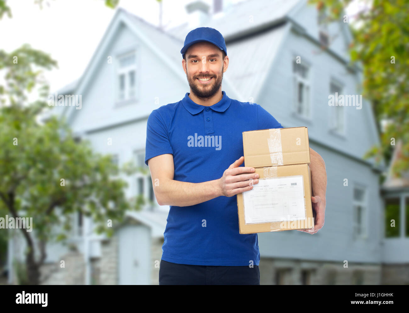 happy delivery man with parcel boxes Stock Photo - Alamy