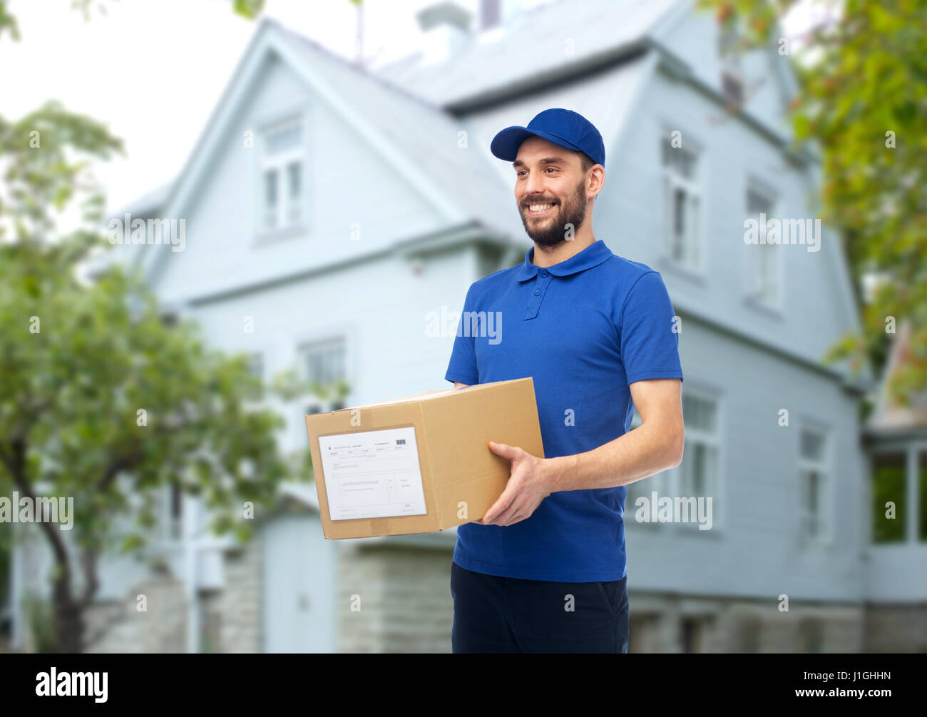 happy delivery man with parcel box Stock Photo - Alamy