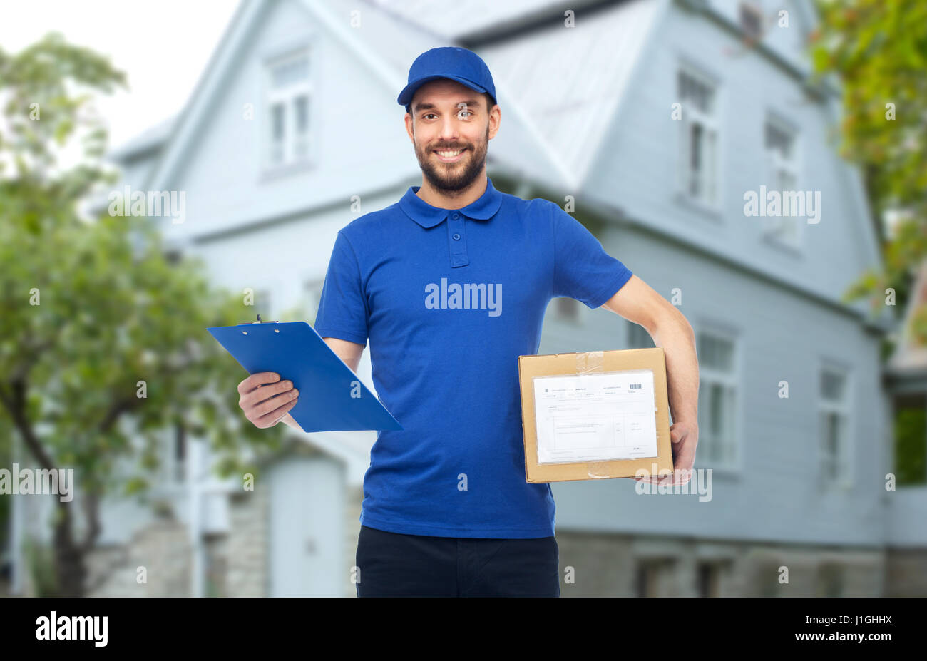 happy delivery man with parcel box and clipboard Stock Photo - Alamy