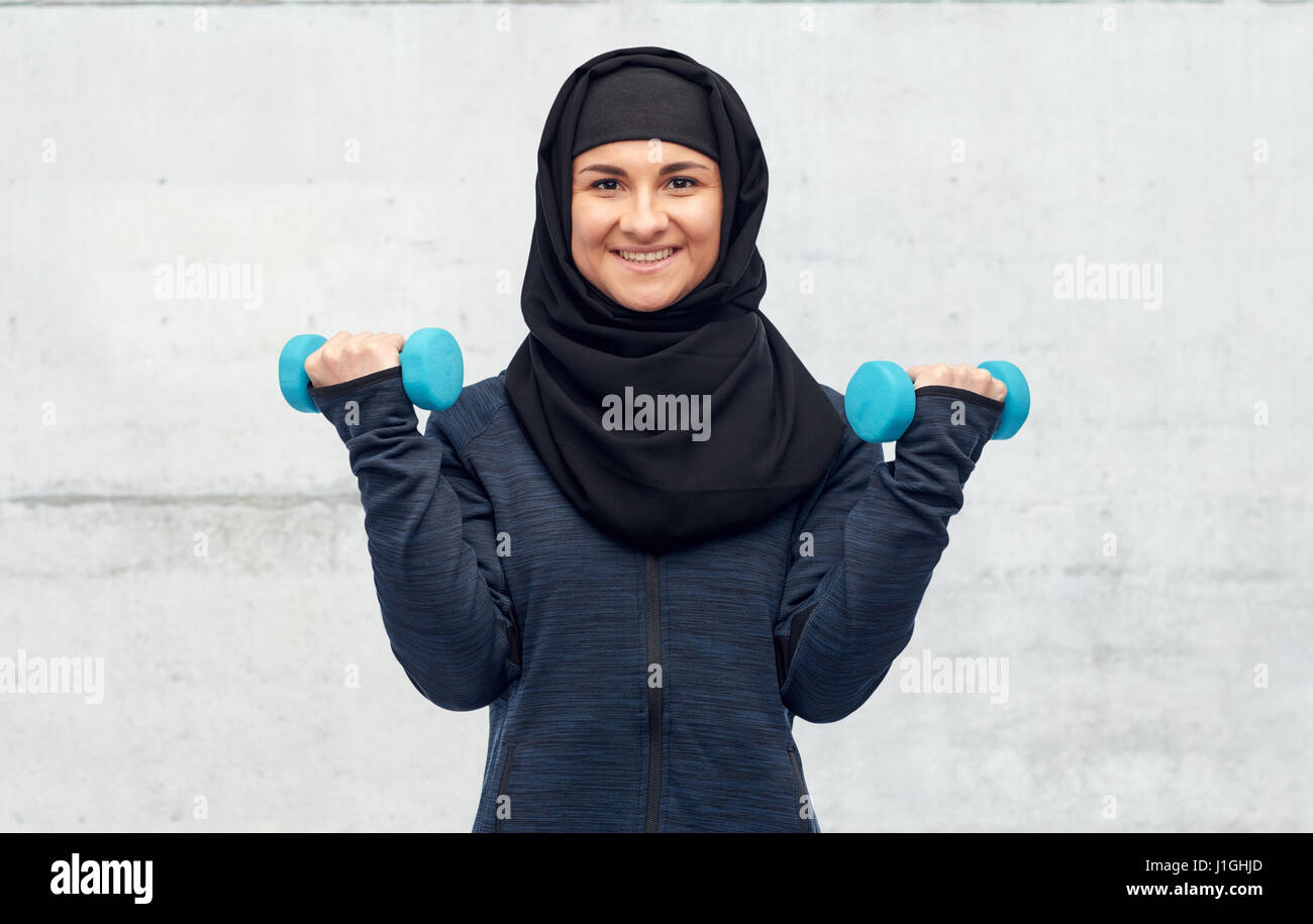 muslim woman in hijab with dumbbells doing fitness Stock Photo - Alamy