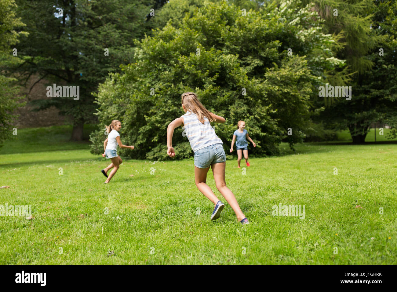 group of happy kids or friends playing outdoors Stock Photo - Alamy