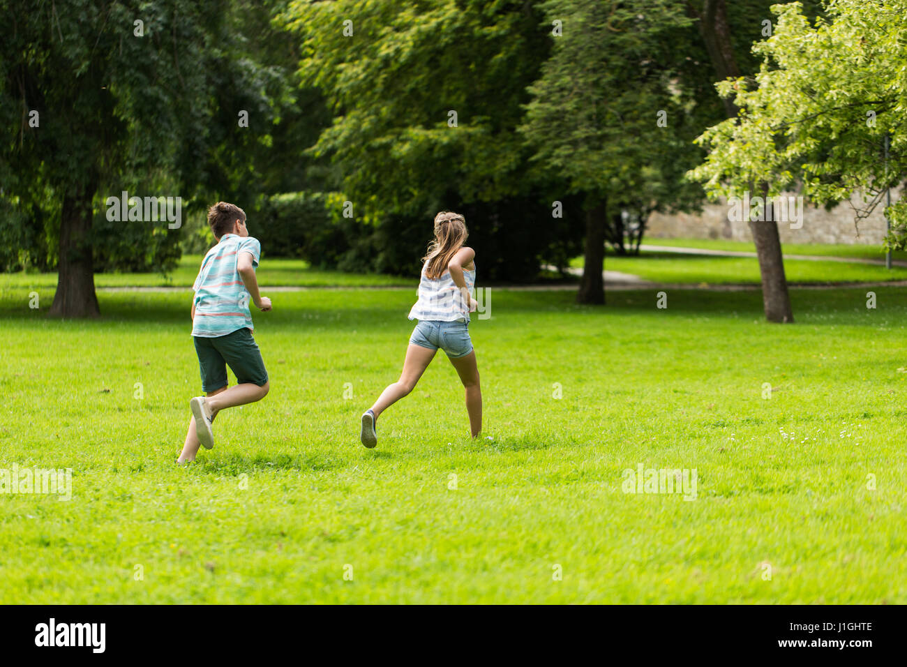 group of happy kids or friends playing outdoors Stock Photo - Alamy