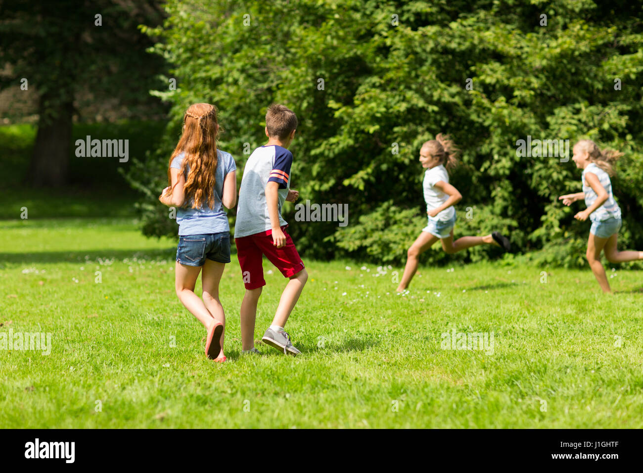 group of happy kids or friends playing outdoors Stock Photo - Alamy