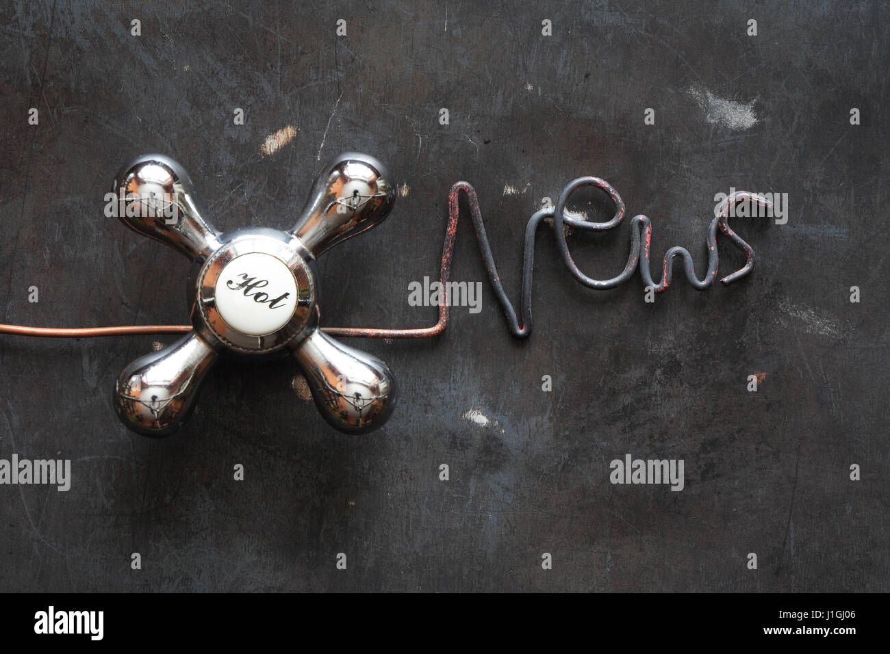 Periodical Press concept. Word News made from metal wire on grange dark ...