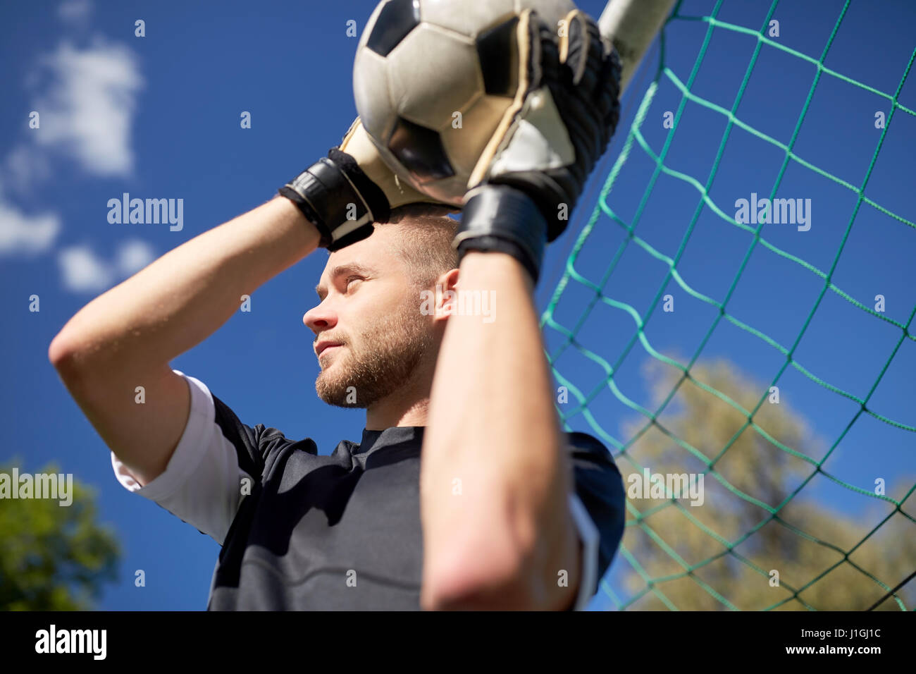 Footballer holding football hi-res stock photography and images - Alamy