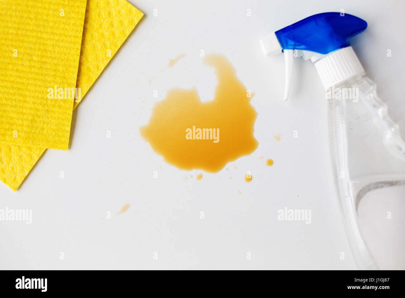 cleaning rag, detergent spray and spilled stain Stock Photo - Alamy