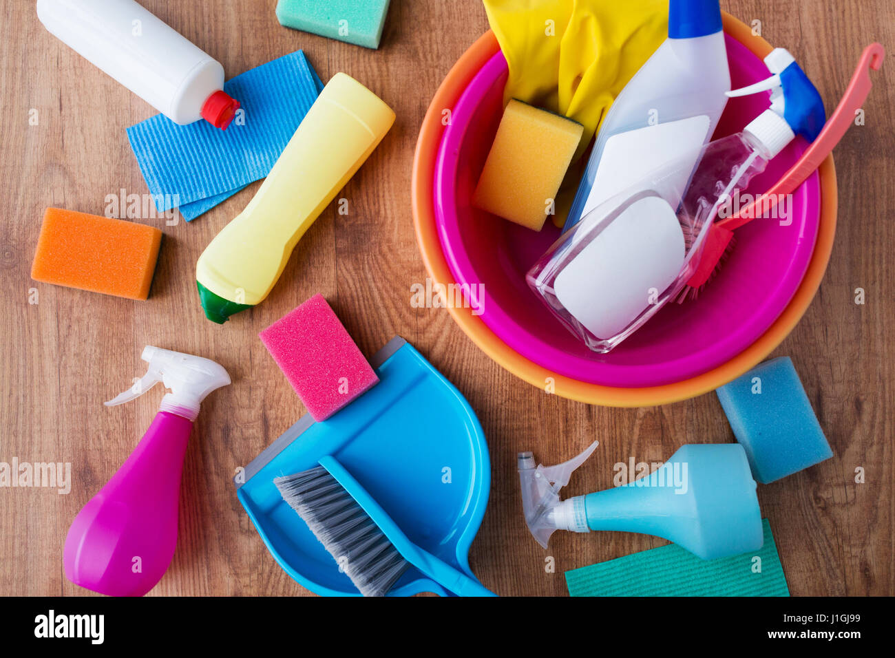 basin with cleaning stuff on wooden floor Stock Photo - Alamy