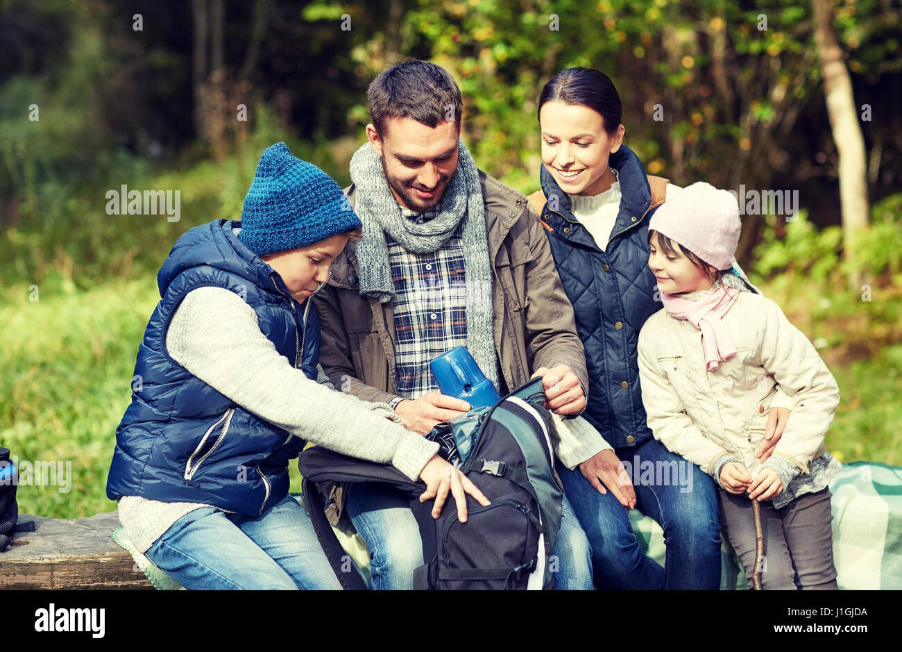 happy family with backpack and thermos at camp Stock Photo - Alamy