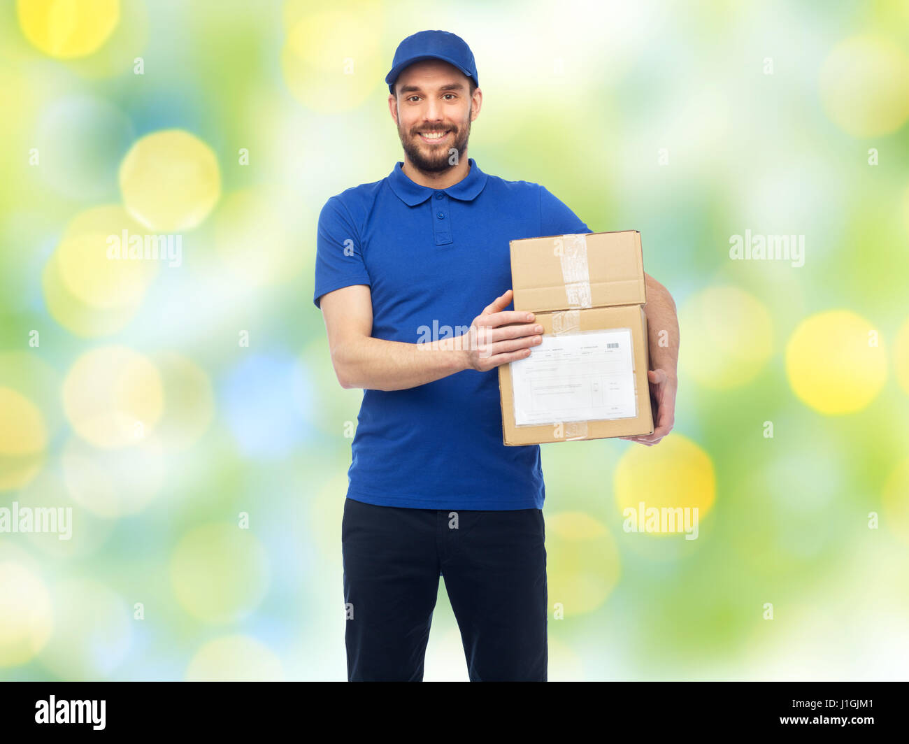 happy delivery man with parcel boxes Stock Photo - Alamy