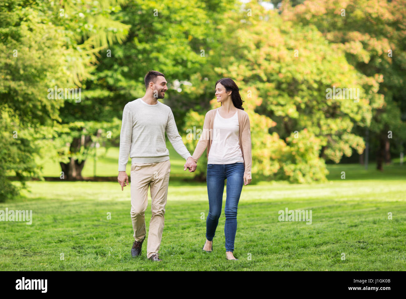 happy couple walking in summer park Stock Photo - Alamy