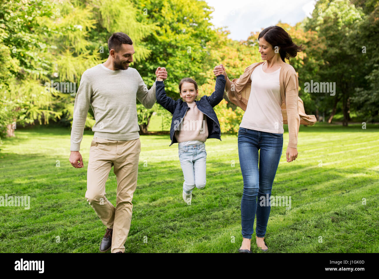 happy family walking in summer park and having fun Stock Photo - Alamy