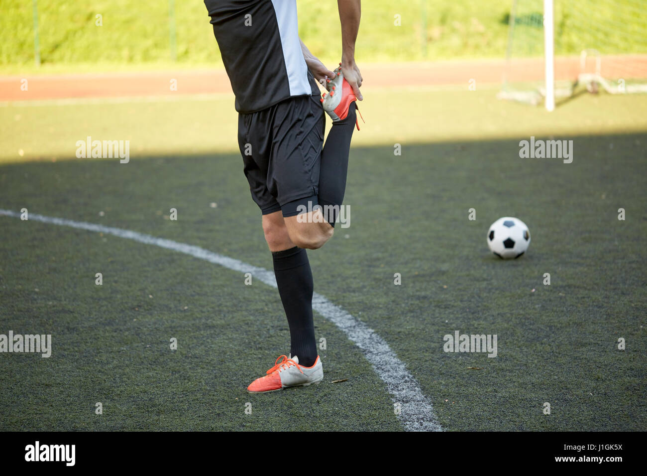 soccer player stretching leg on field football Stock Photo - Alamy