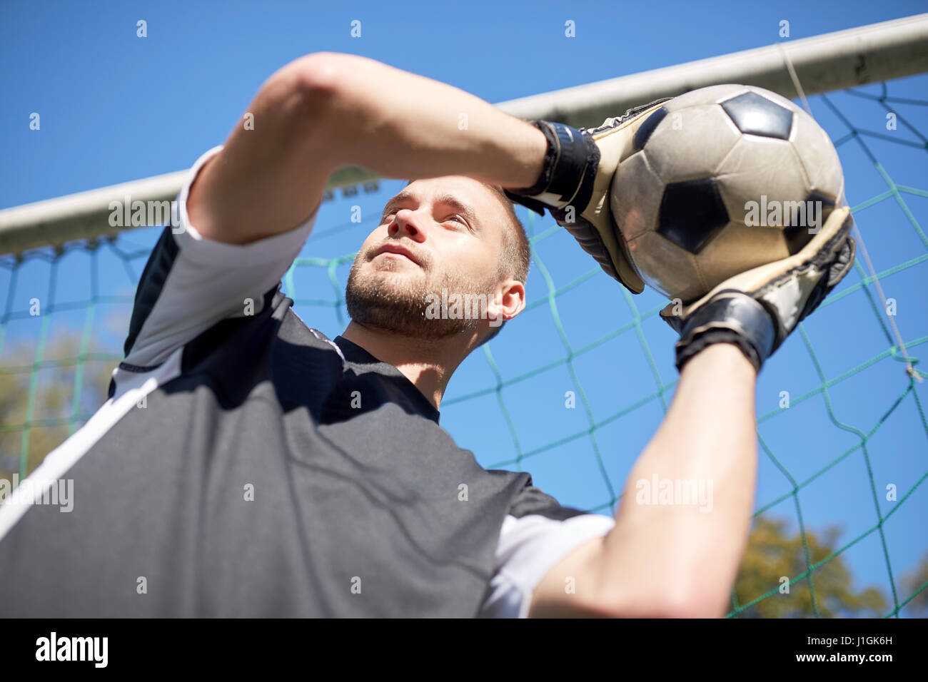 goalkeeper with ball at football goal on field Stock Photo - Alamy