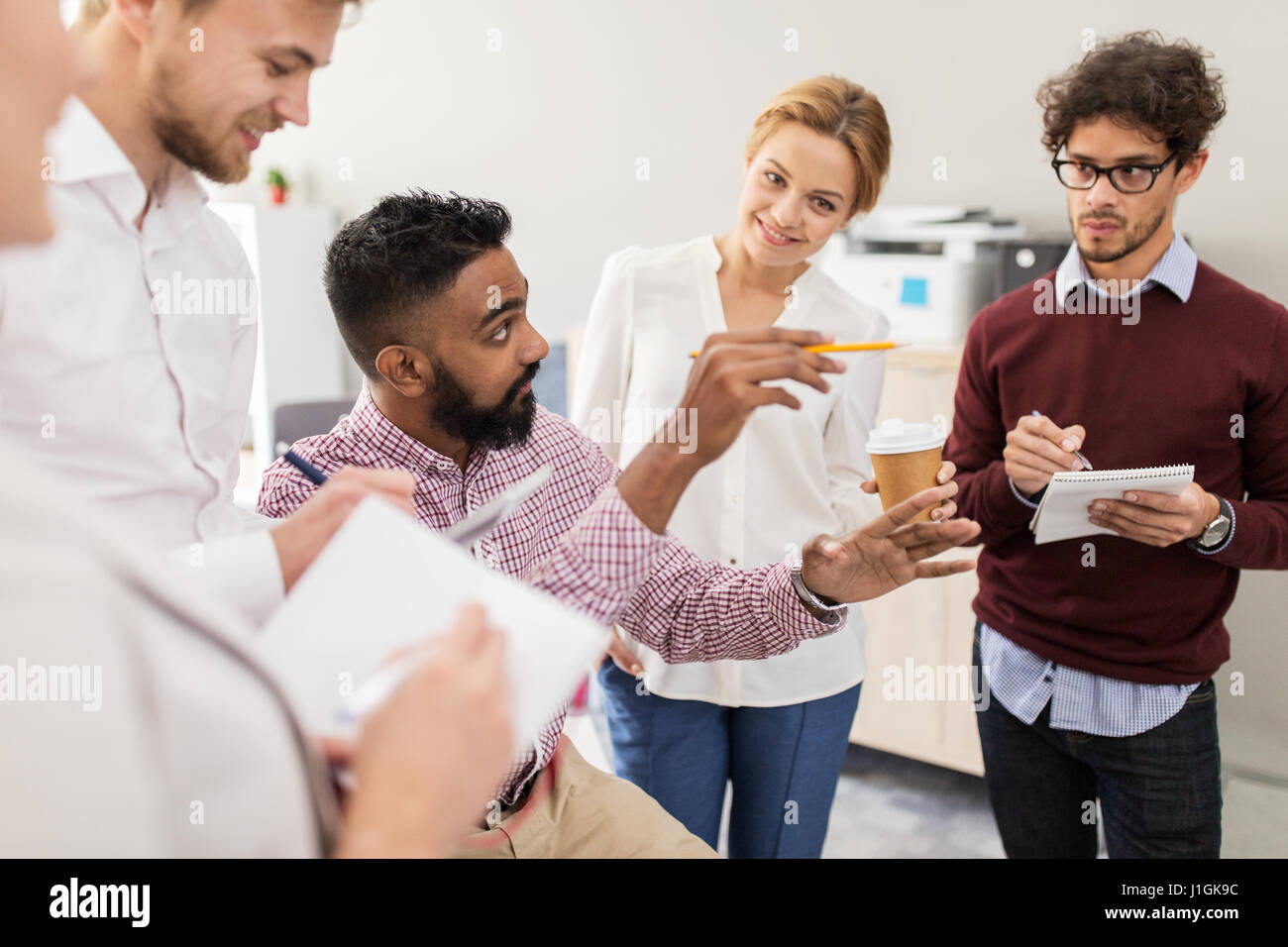 happy business team discussing something at office Stock Photo - Alamy