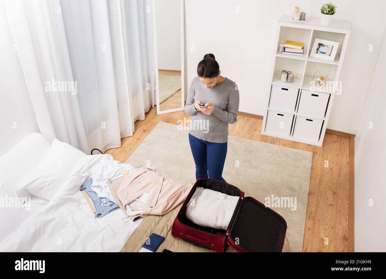 woman packing travel bag at home or hotel room Stock Photo - Alamy