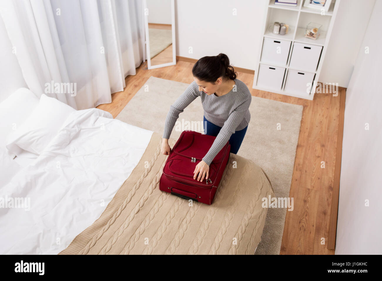 Woman packing suitcase hotel room hi-res stock photography and images ...