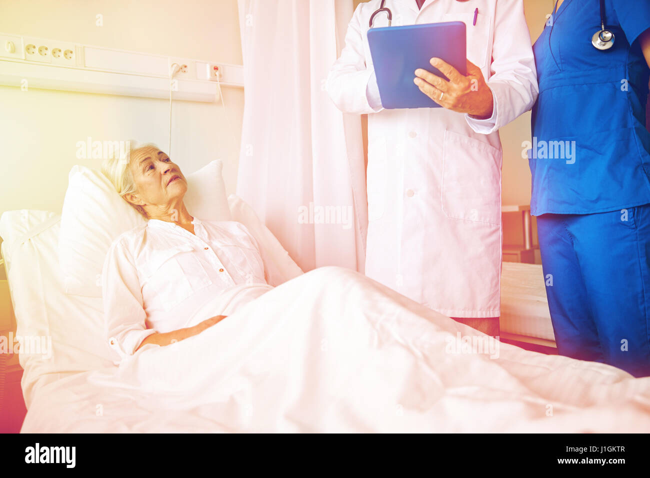 doctor and nurse visiting senior woman at hospital Stock Photo - Alamy