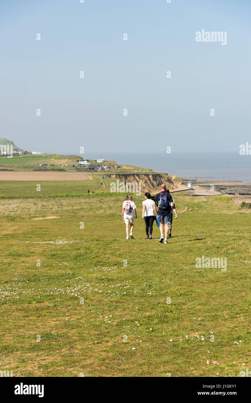 A group of people walk on the North Norfolk Coast Path near Beeston ...