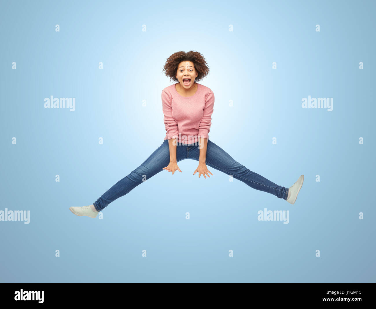happy african american woman jumping over white Stock Photo - Alamy